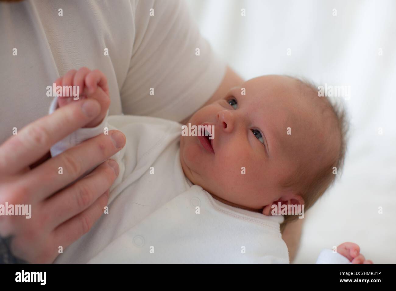 A newborn baby being held by his parents Stock Photo - Alamy