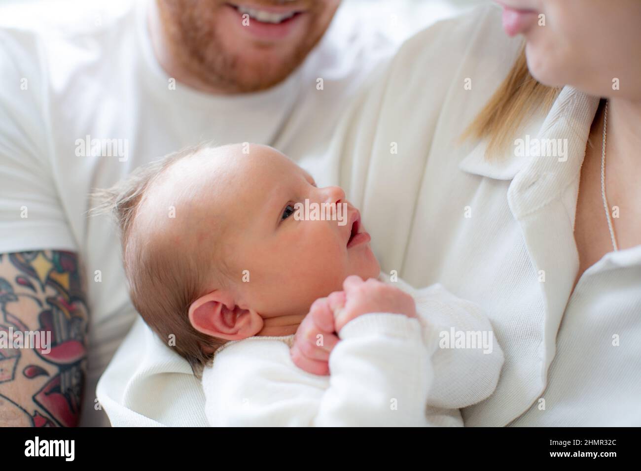 A newborn baby being held by his parents Stock Photo - Alamy