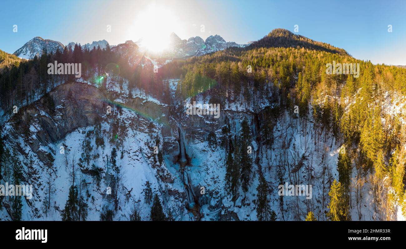 Spectacular mountain panorama with waterfall falling across forest ...