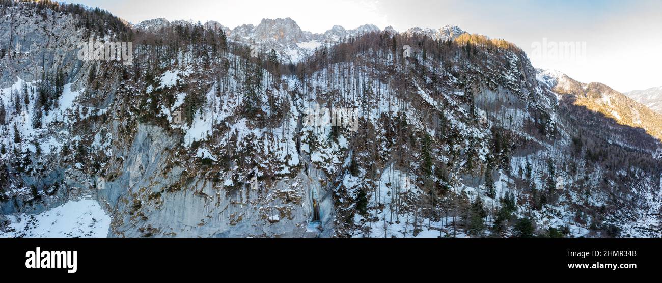 Spectacular mountain panorama with waterfall falling across forest ...