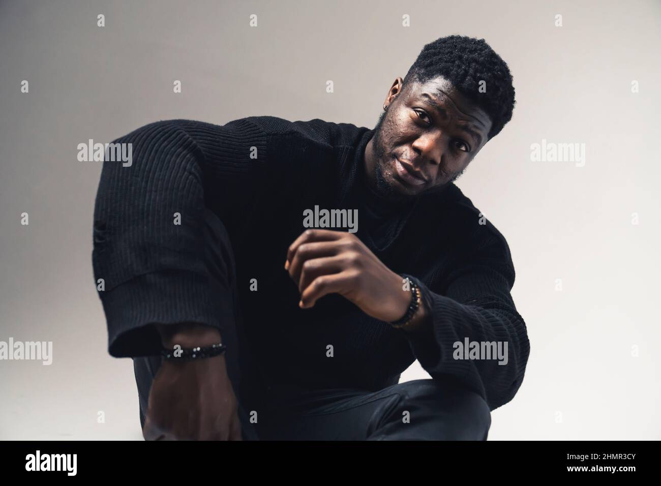 American black men with serious expression seated white background ...