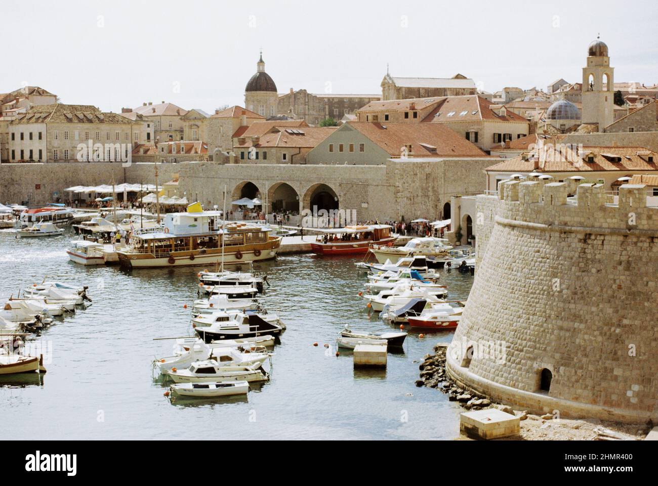 Boats stand on the pier in front of the ancient fortress. Dubrovnik ...
