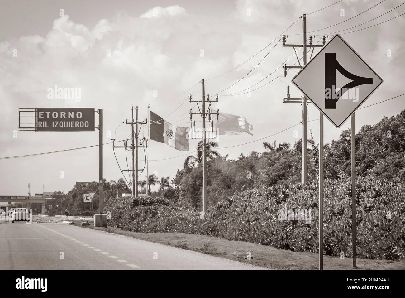 Black and white picture of a broken damaged green turquoise road sign ...