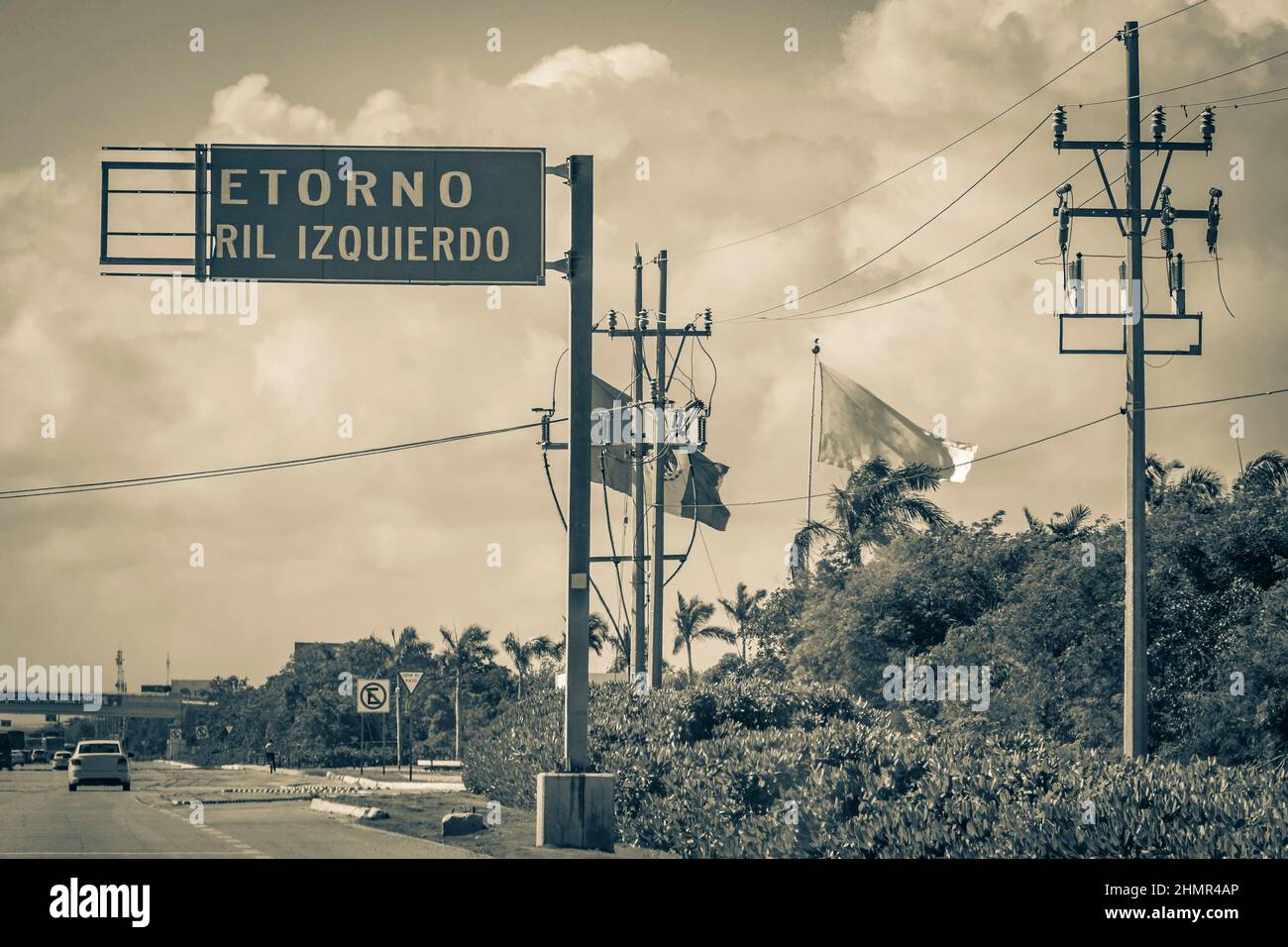 Black and white picture of a broken damaged green turquoise road sign ...