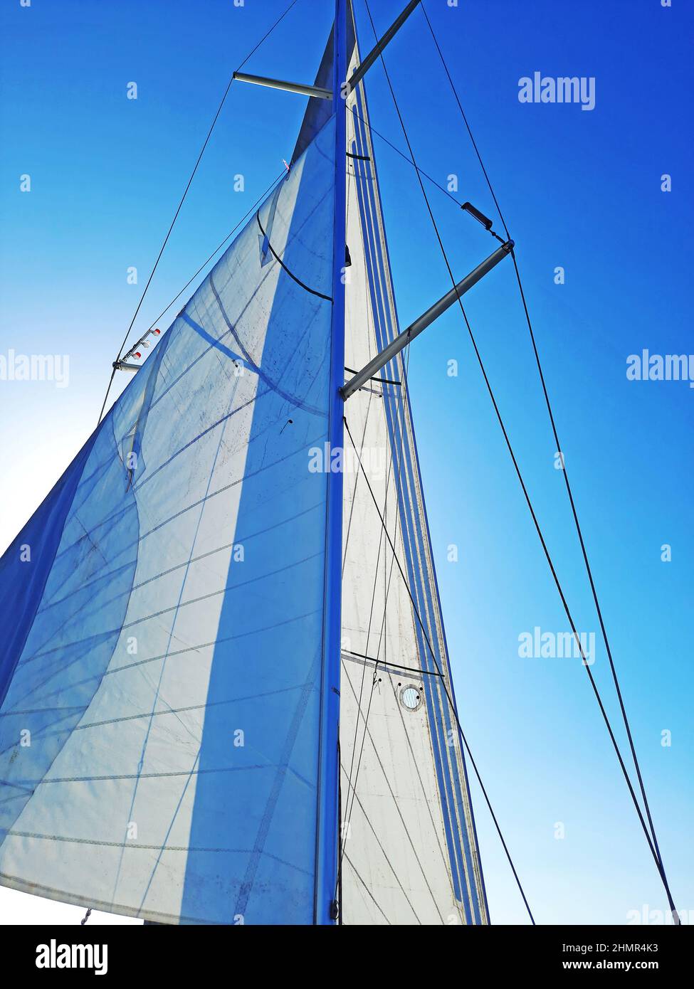 Yacht wind filled sails on clear blue sky background. Sailing with the ...