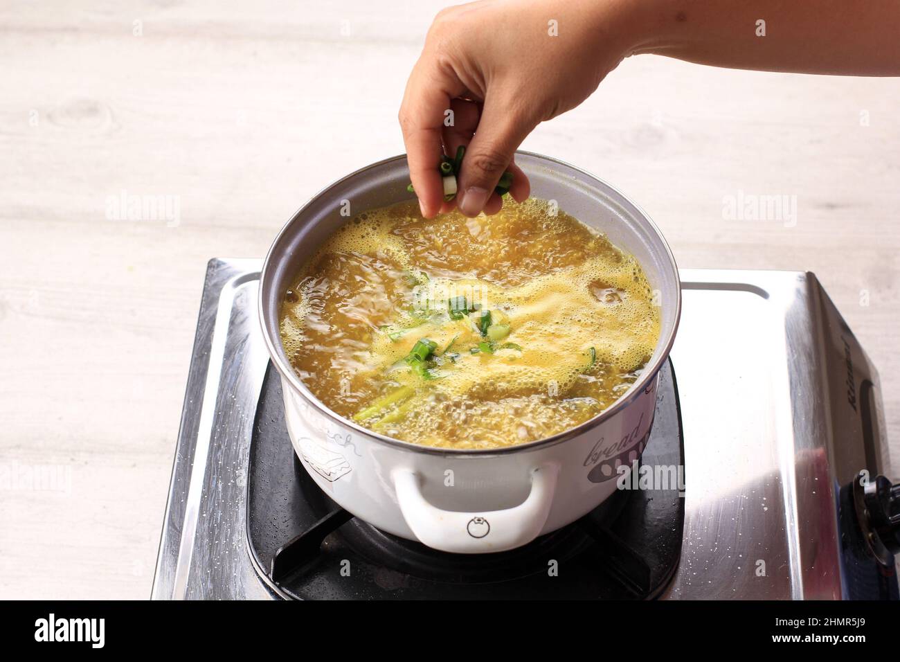 Add Chopped Spring Onion to the pan with Yellow Soup (Soto). Cooking ...