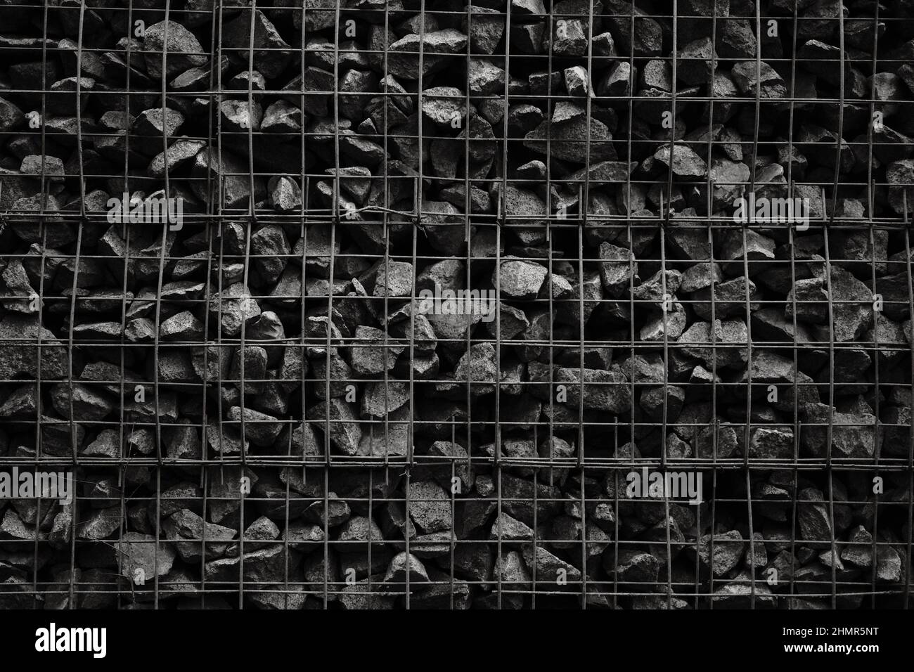 Grayscale of rocks in a steel container Stock Photo - Alamy