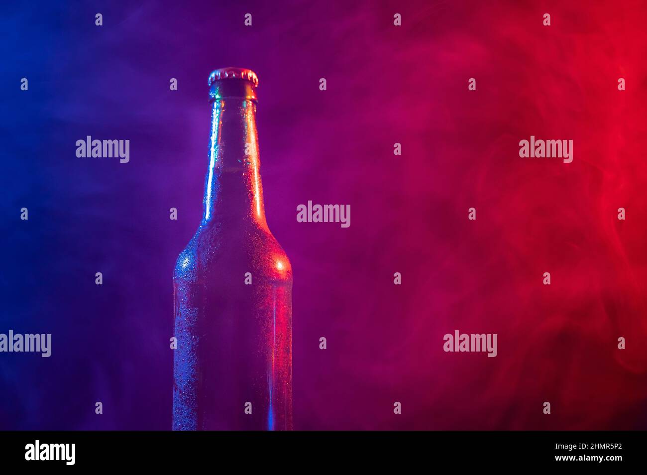Glass bottle of beer in blue pink mist Stock Photo - Alamy