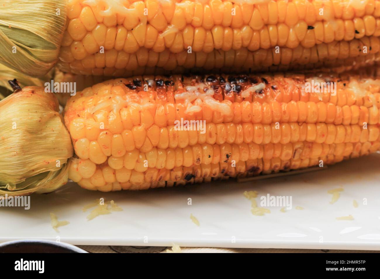 Grilled Sweet Corn with Butter and Shredded Mozarella. Served on White ...