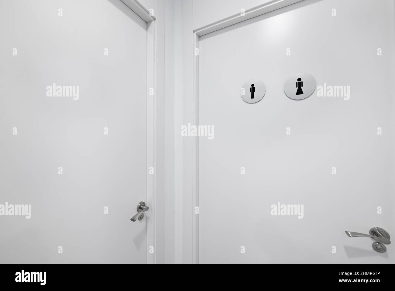 White entrance doors with signs for men and women Stock Photo - Alamy