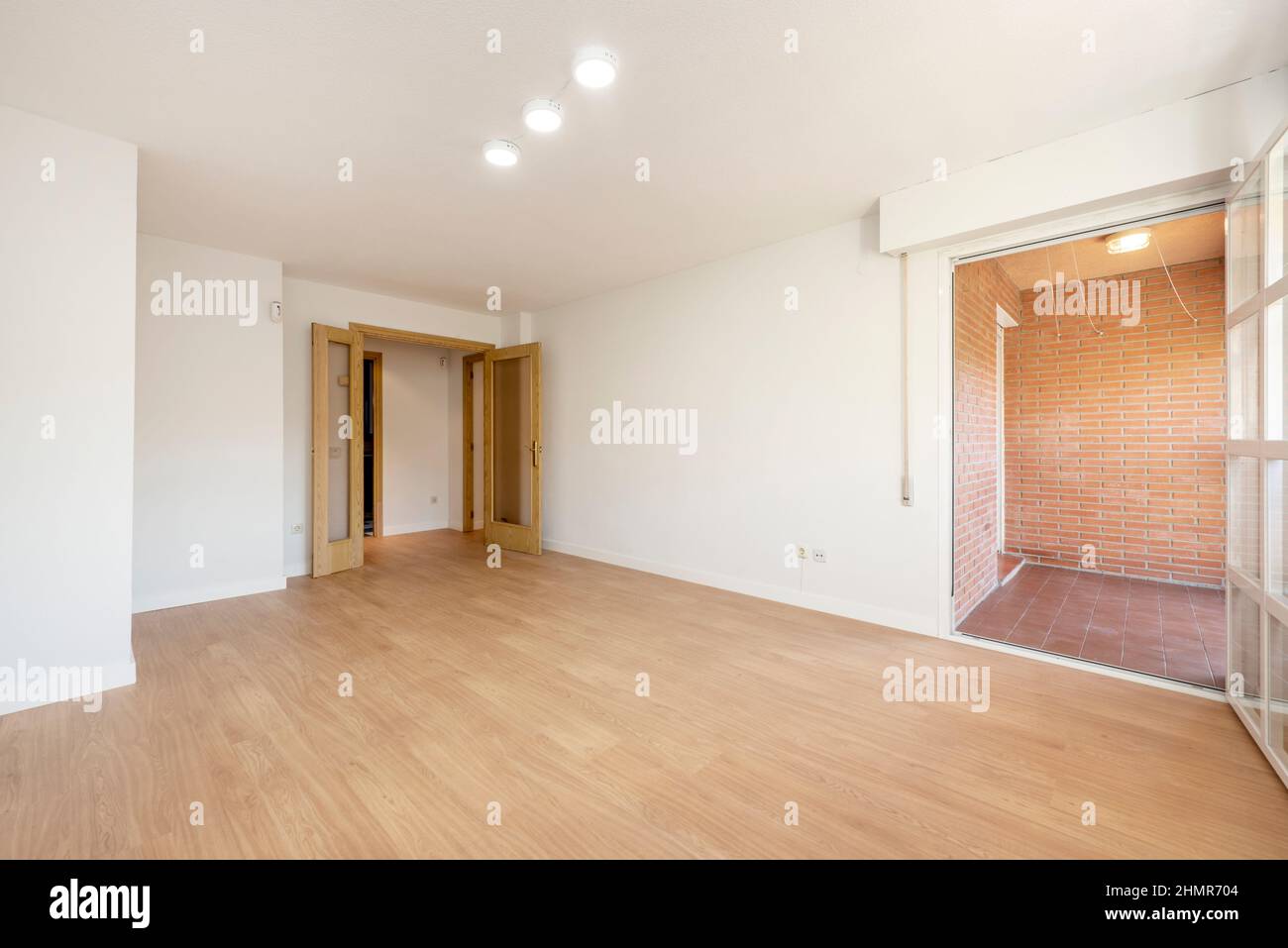 empty living room with furniture with wooden floors, freshly painted ...
