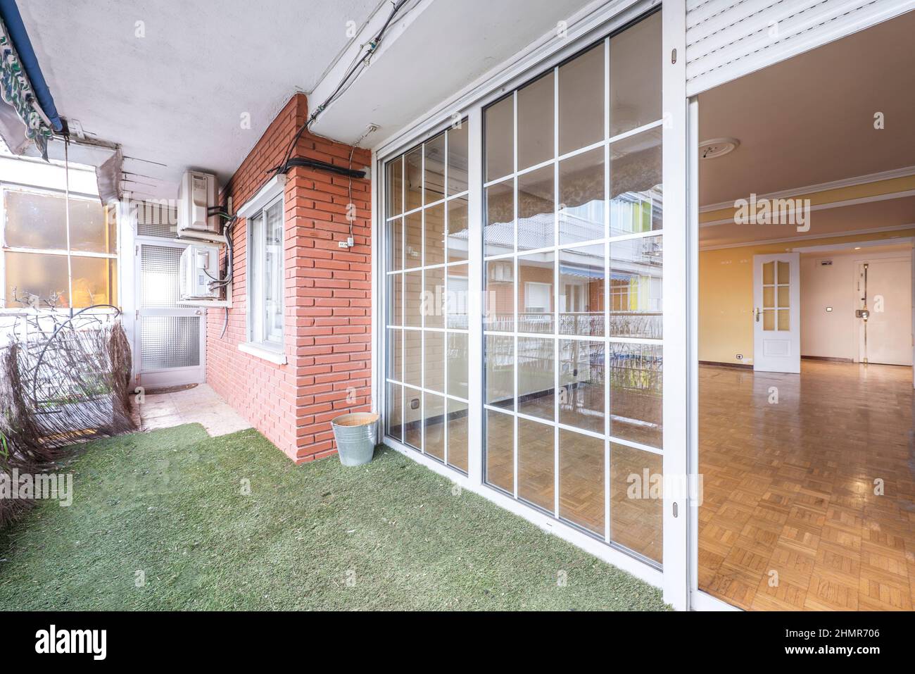 Terrace with similar artificial grass floor and white aluminum barred ...
