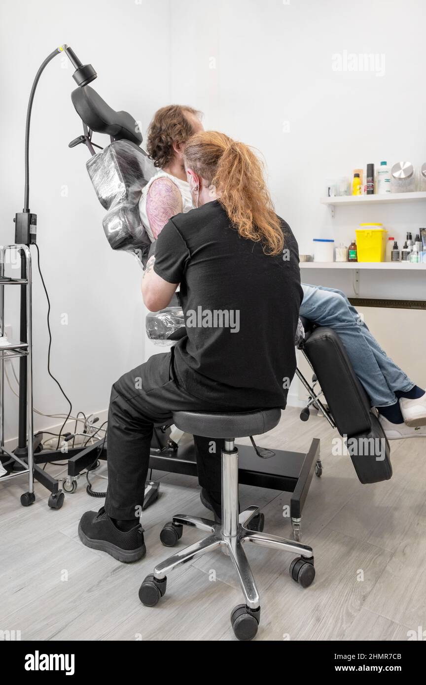 Tattoo artist making tattoo at the studio. High quality photography ...