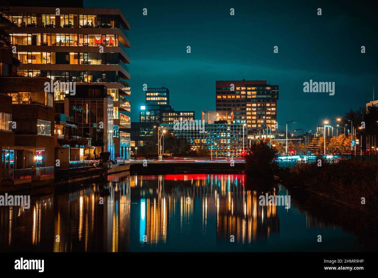 Beautiful exterior view of urban colorful buildings at night reflecting ...