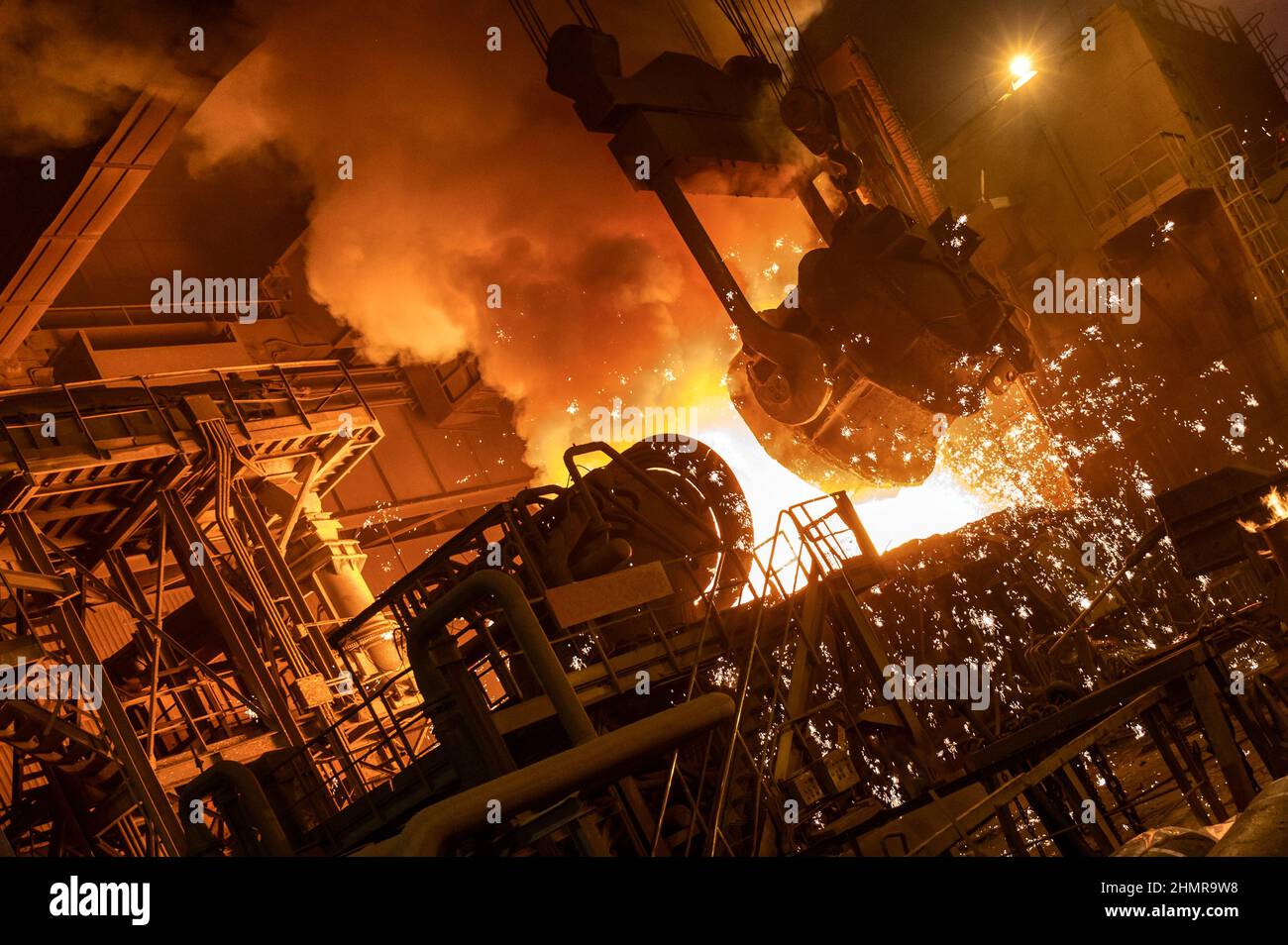 The process of pouring molten steel into a metallurgical furnace Stock ...