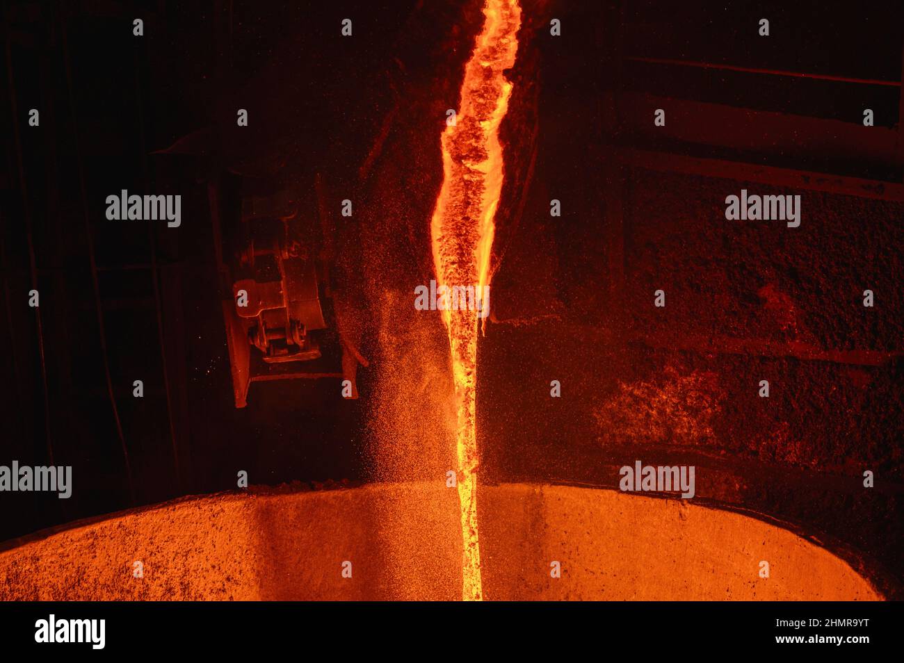 A stream of molten slag is poured into a metallurgical ladle Stock ...