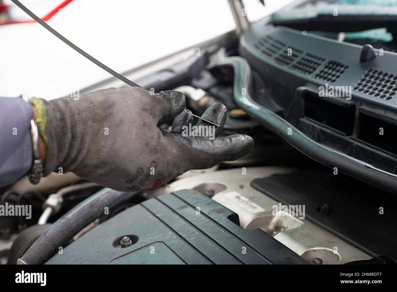 Mechanic man hand checking car engine oil maintanance vehicle Stock ...