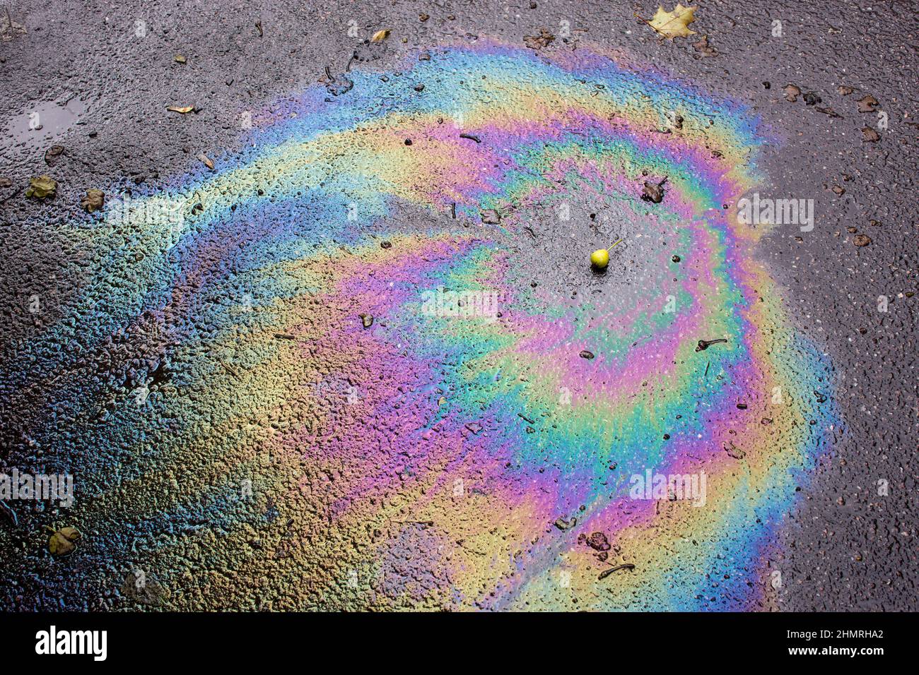 Iridescent spot of gasoline. Petrol on the asphalt a big polluted ...