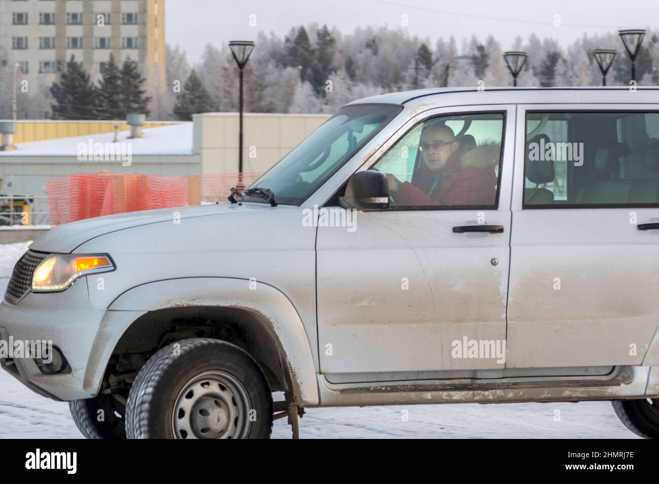 Portrait of the driver in the passenger compartment of the car behind ...