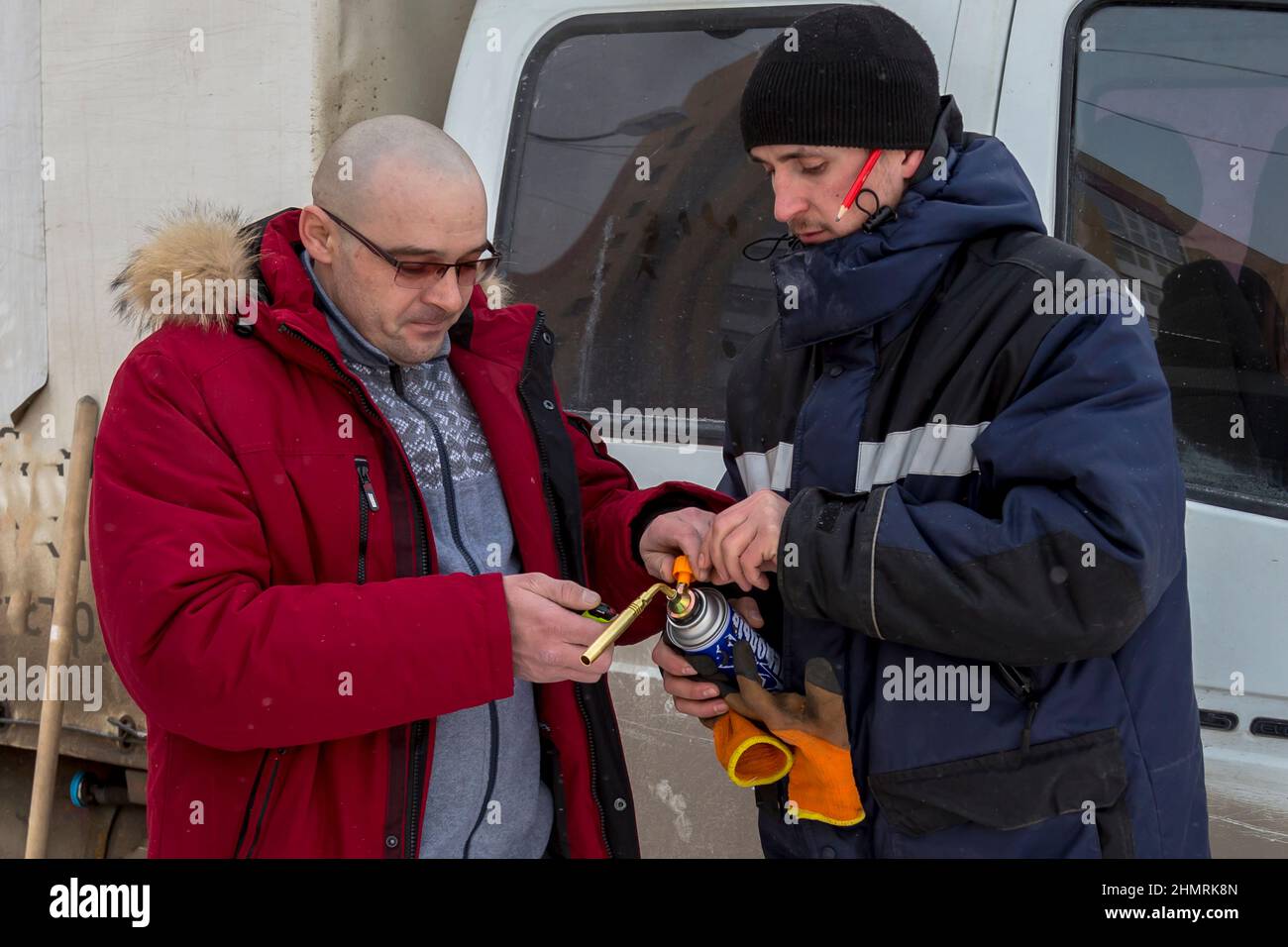 Installers setting up a gas burner at a construction site Stock Photo ...