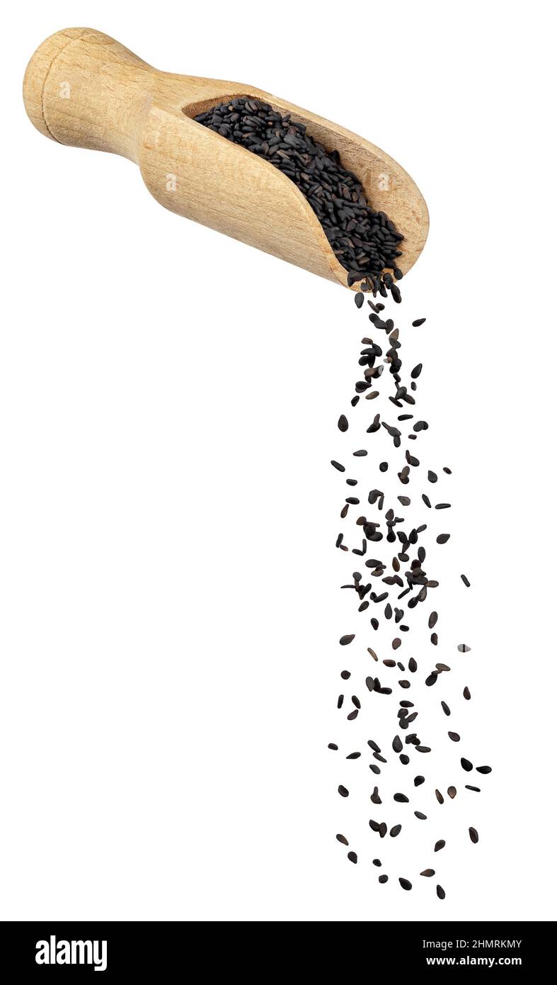 black sesame seeds falling from wooden spoon Stock Photo - Alamy