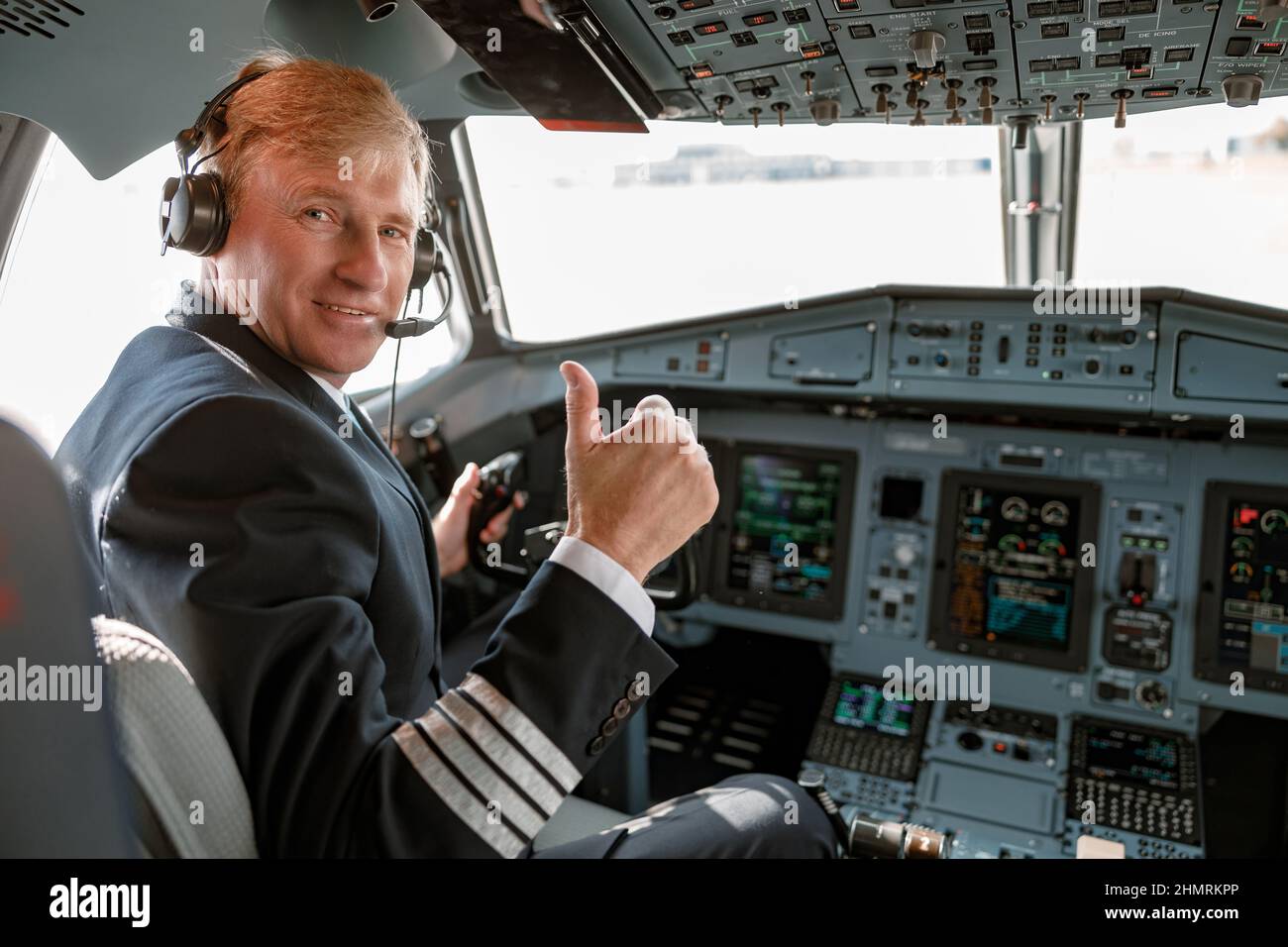 Male pilot sitting in airplane cockpit and giving thumbs up Stock Photo ...