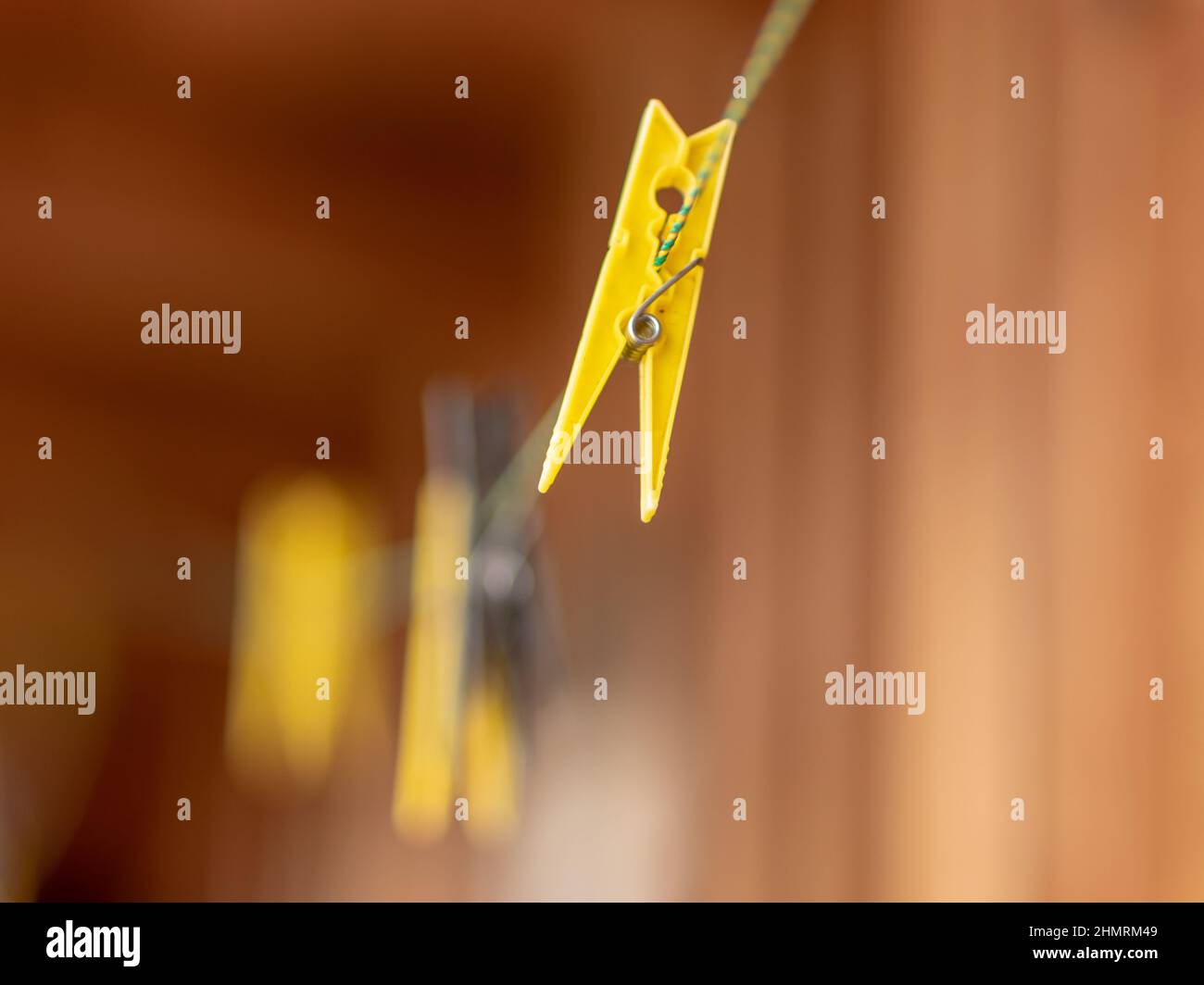 clothes pegs on clothesline, blurred background of wooden boards, close ...