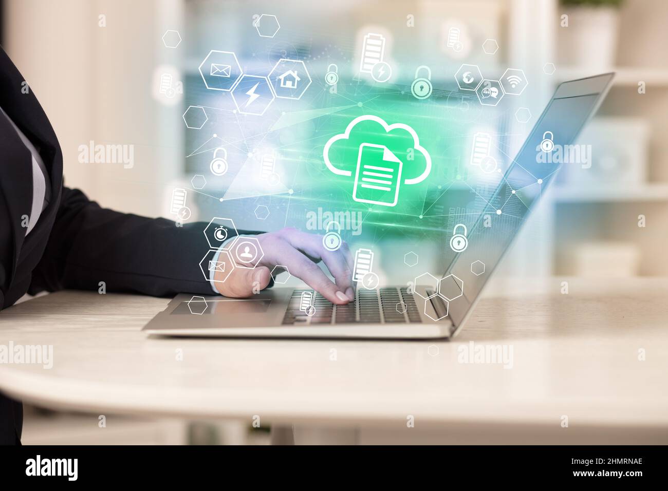 Hands working on laptop with digital icons Stock Photo - Alamy