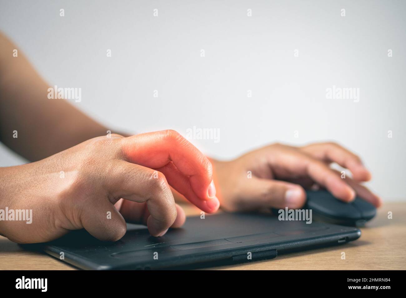 The man uses a mouse and drawing pad until his fingers pain. Office ...