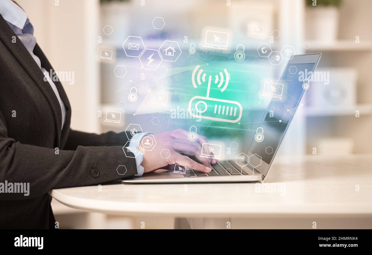 Hands working on laptop with digital icons Stock Photo - Alamy