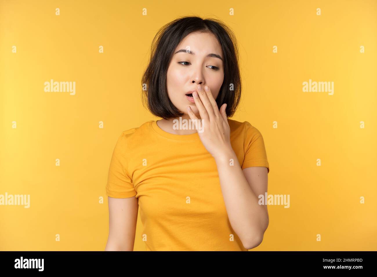 Image of young asian girl student, yawning, feeling tired, standing ...