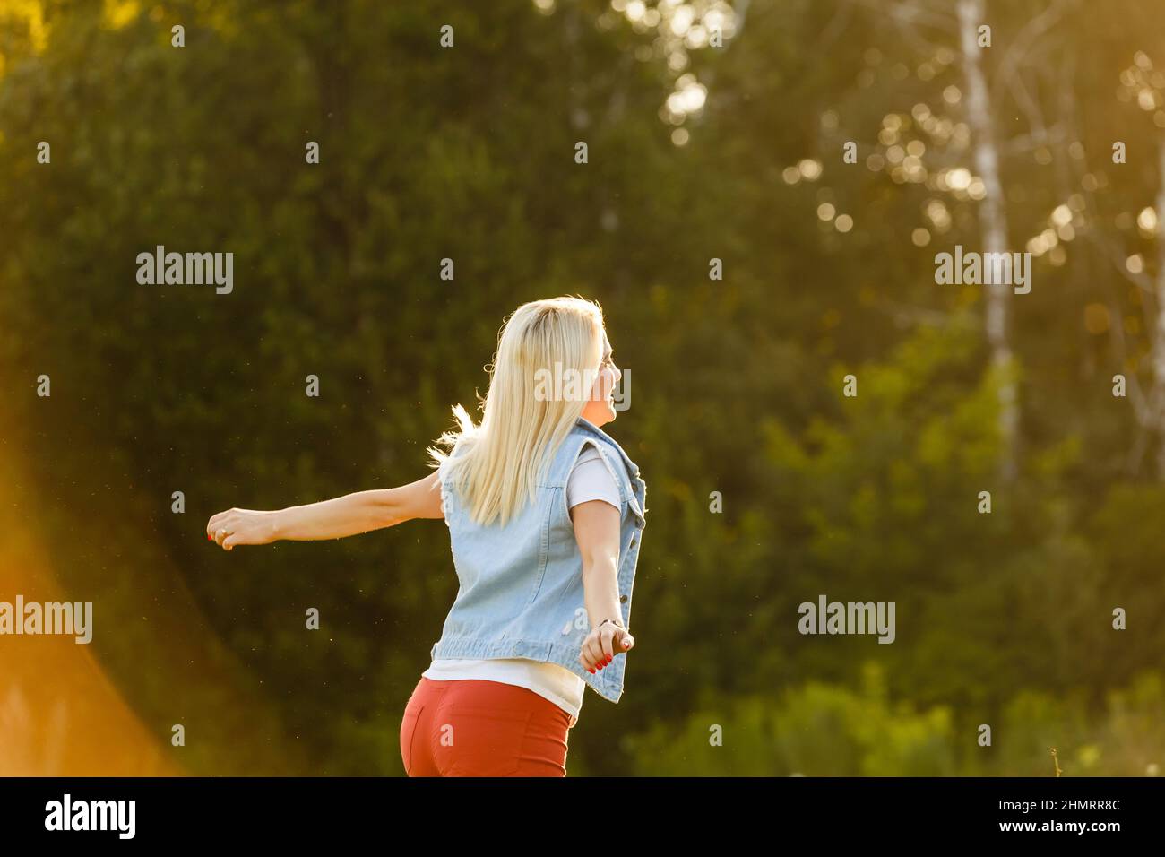 beautiful young blond woman alone in the park Stock Photo - Alamy