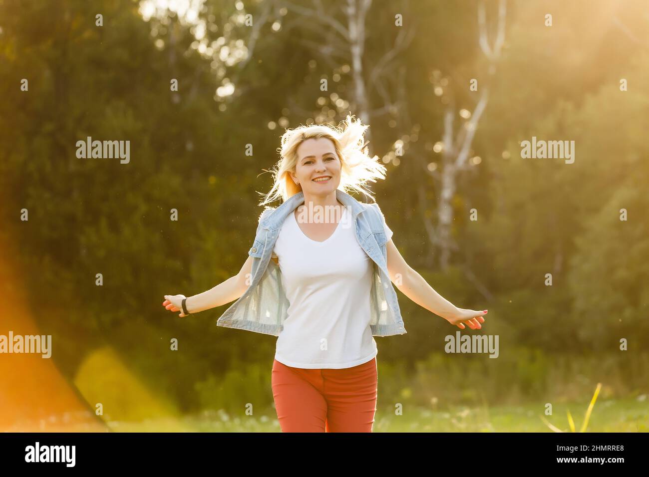 Girl running across field Stock Photo - Alamy