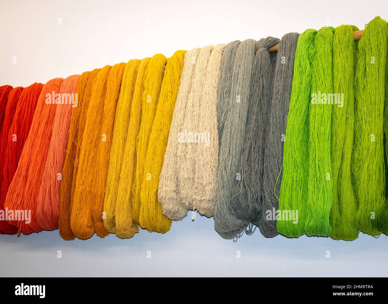 wool yarn threads, colored yarn skeins on the wall, knitting as a hobby ...