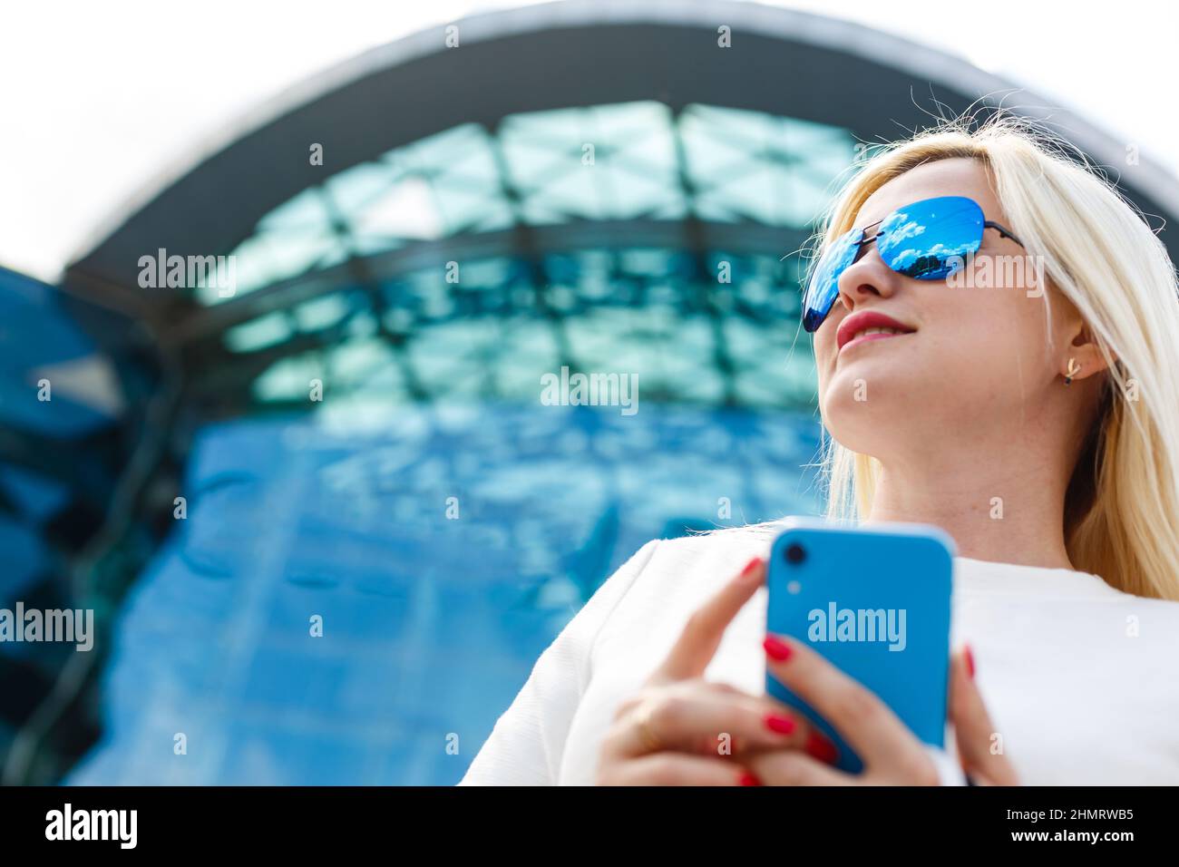 Successful travel blogger checking email box on mobile phone app while ...