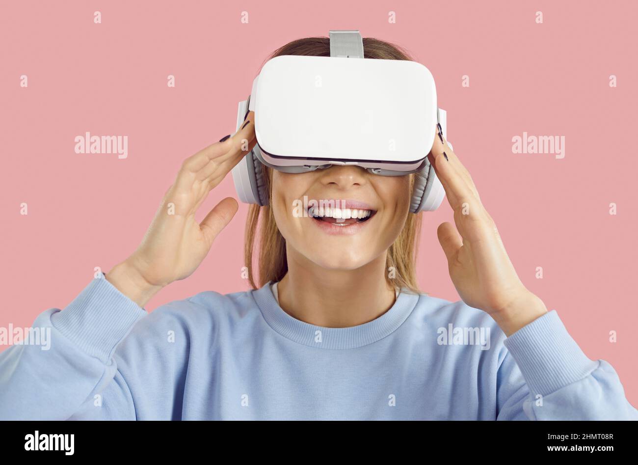 Happy smiling young girl experiencing virtual reality in her innovative ...