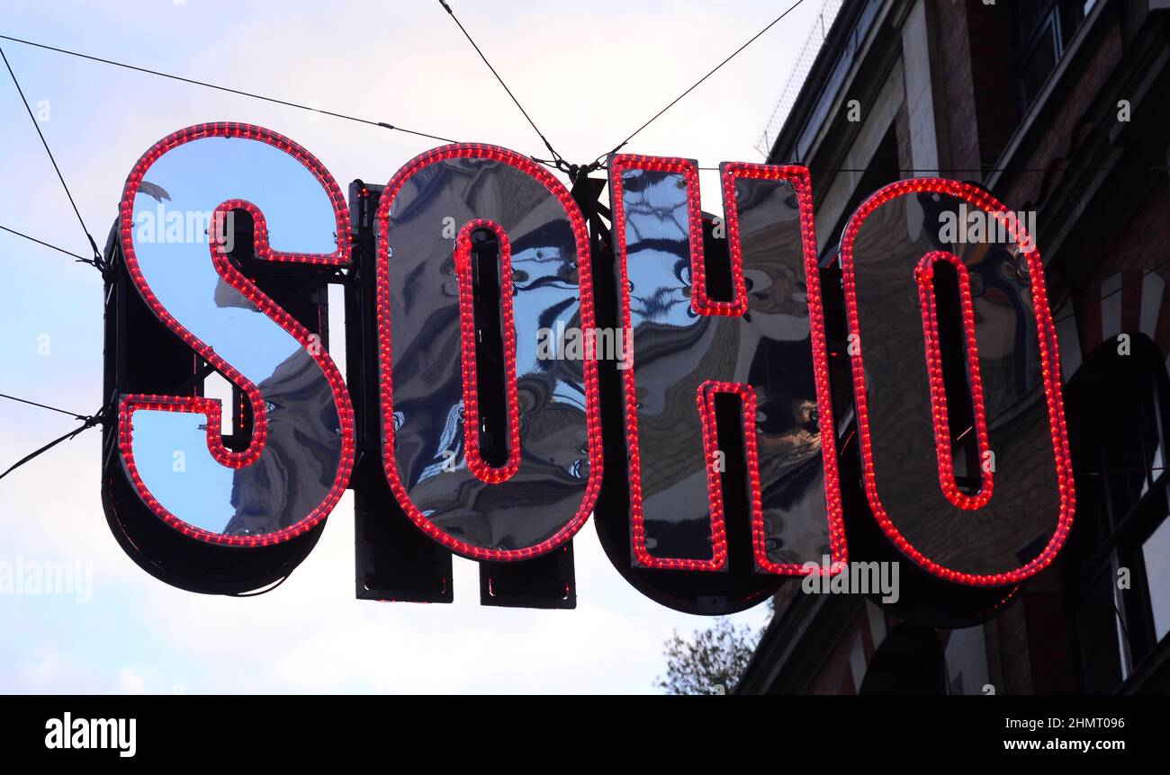A 'Soho' sign or signage above Beak Street, Soho, London, UK, welcome ...