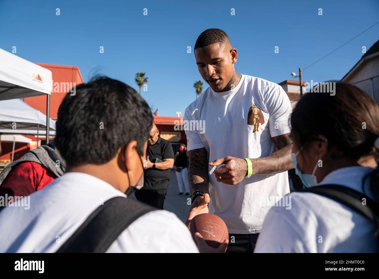 Darren Waller of the Las Vegas Raiders signs a football for a ...