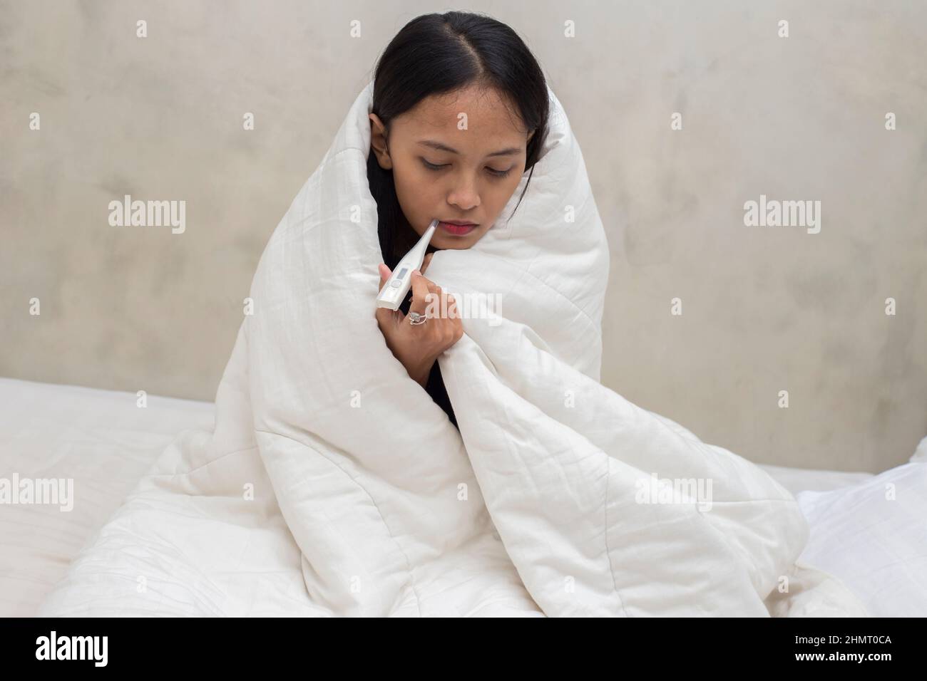 Asian woman feeling sick problems fever and cough sleeping on bed at ...