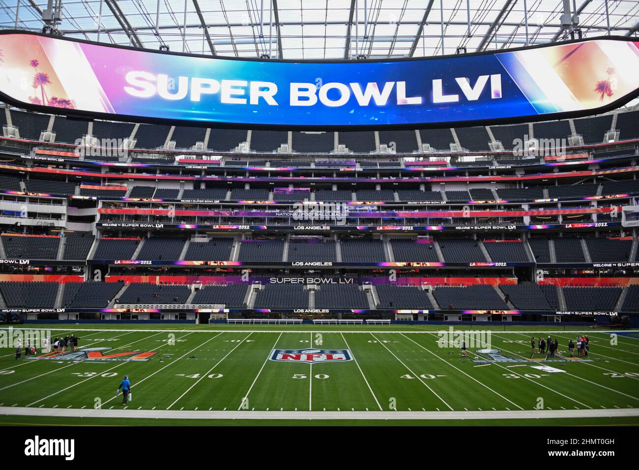 Crews paint the NFL and Super Bowl LVI logos on the field at SoFi ...