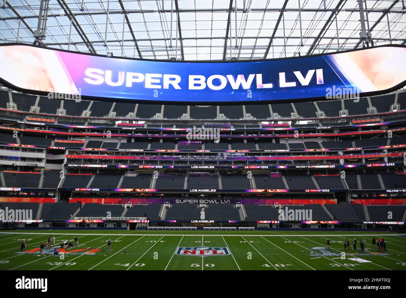 Crews paint the NFL and Super Bowl LVI logos on the field at SoFi ...