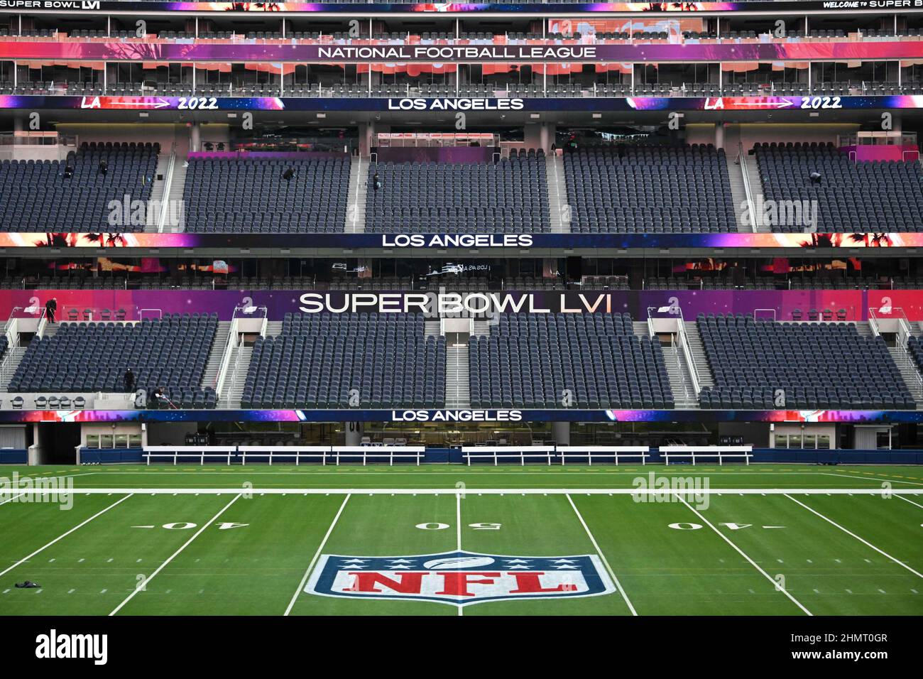 Crews paint the NFL and Super Bowl LVI logos on the field at SoFi ...