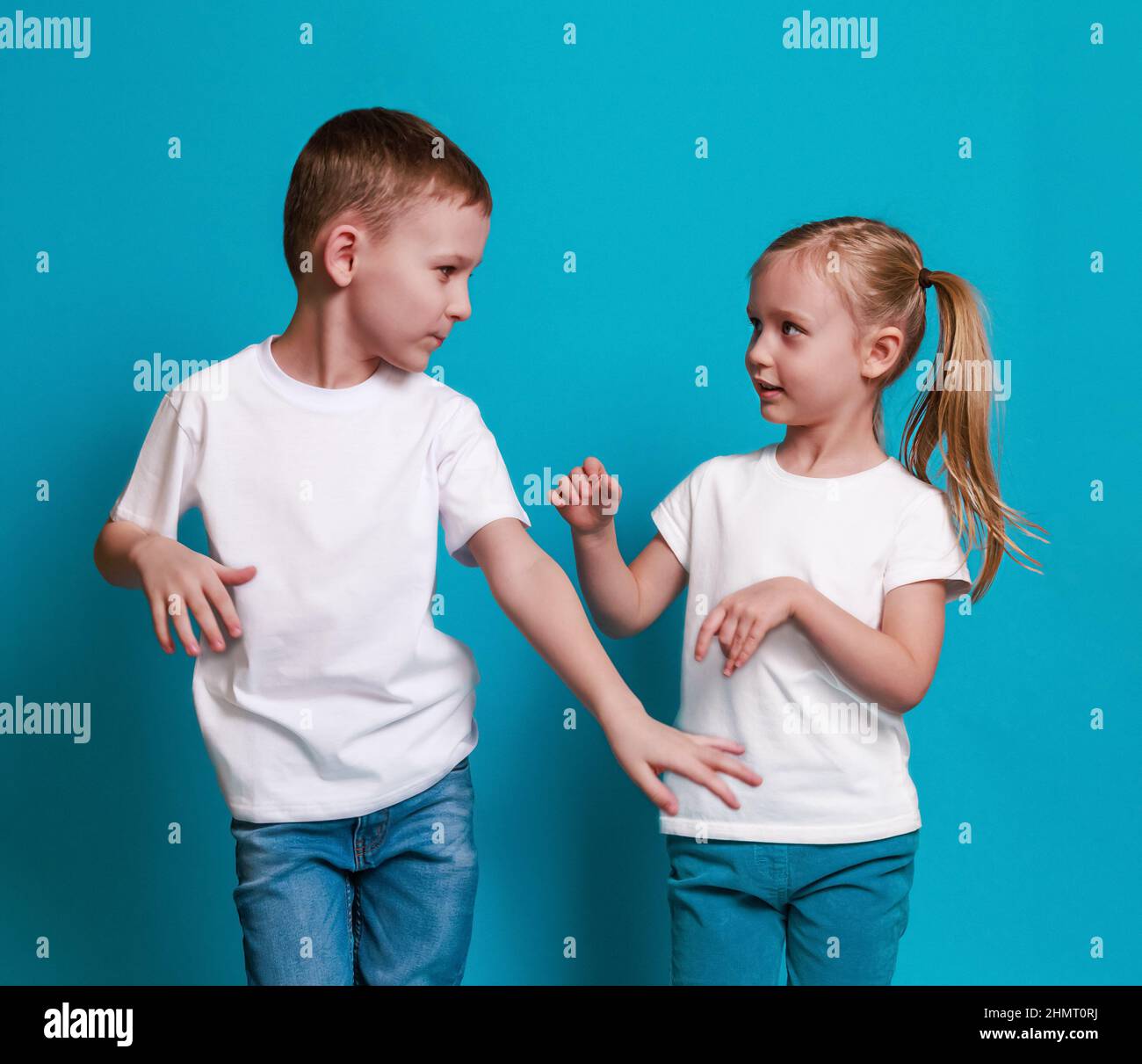 Mocap, caucasian boy and girl dancing in white t-shirts on a blue ...