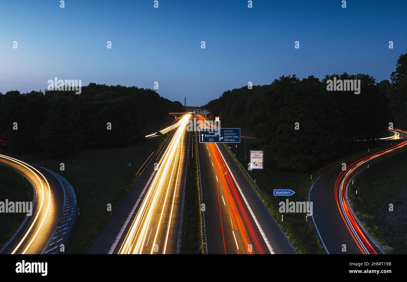 highway crossing with lighttrails at night Stock Photo - Alamy