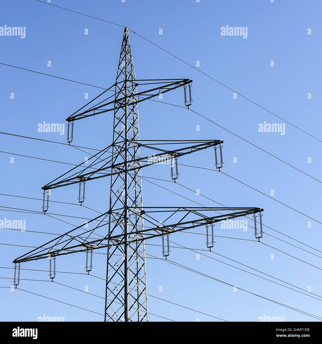 Electricity pylon close-up power pole high voltage against blue sky ...