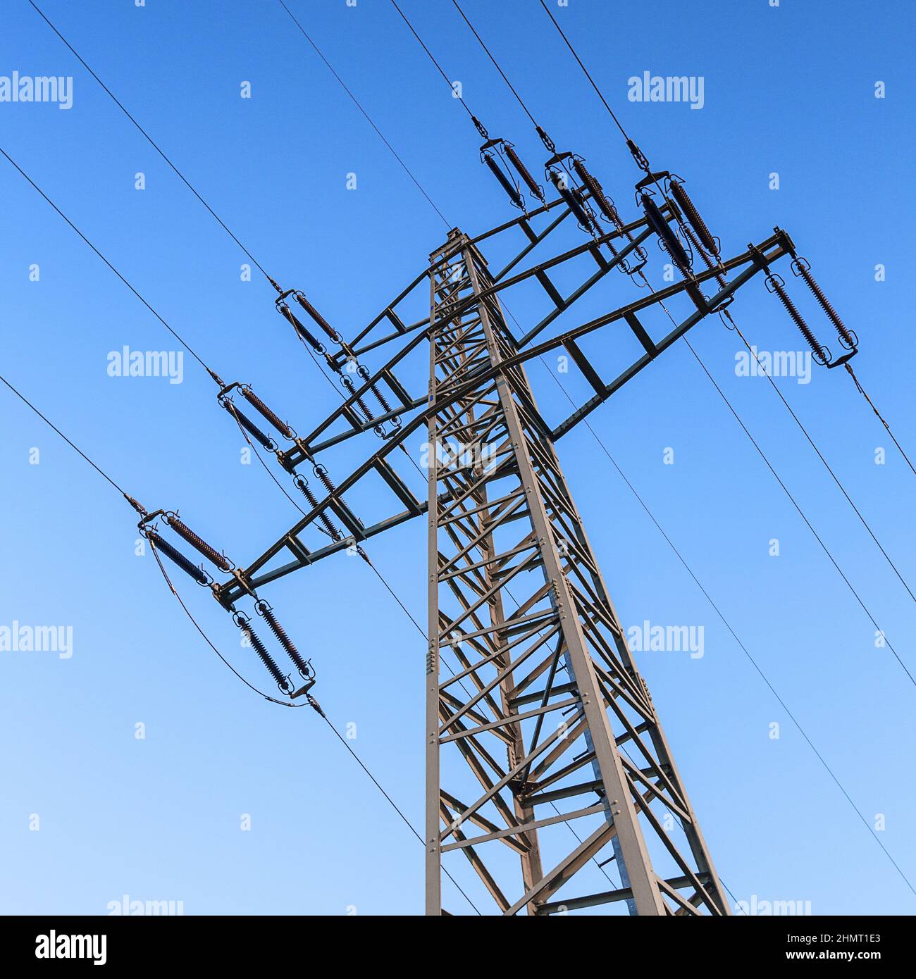 Electricity pylon close-up power pole high voltage against blue sky ...