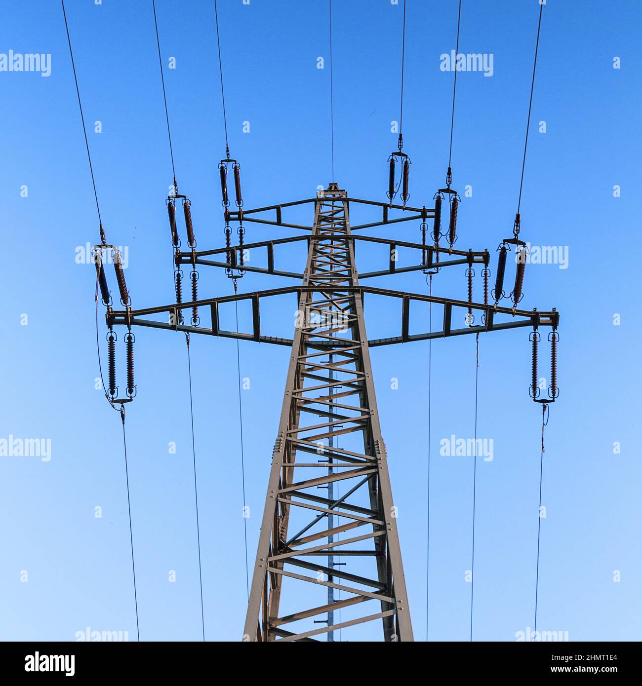 Electricity pylon close-up power pole high voltage against blue sky ...