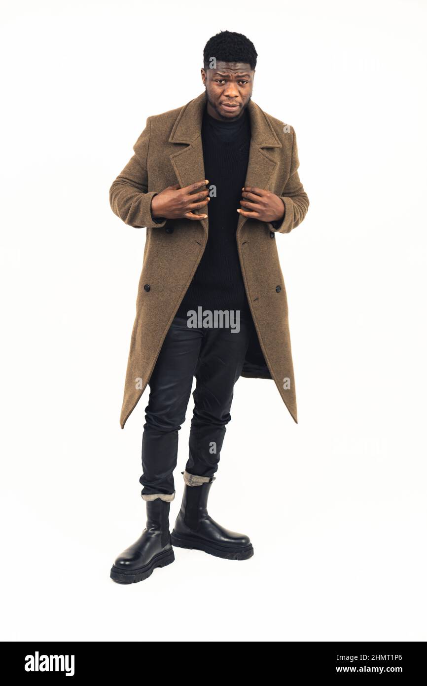 serious black man modeling brown coat white background - full shot ...