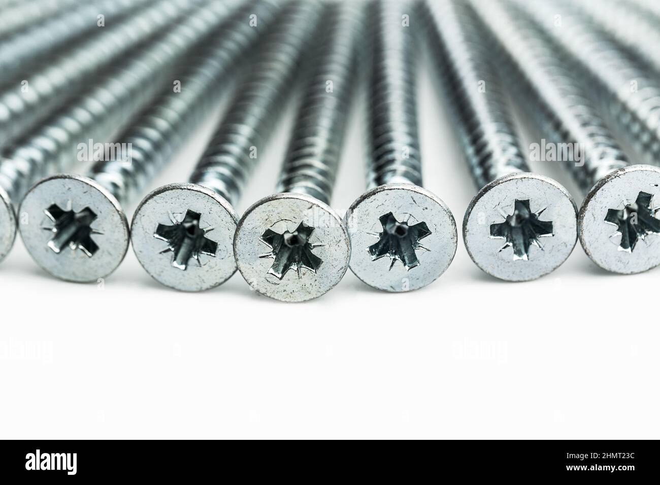 silver screws on white background Stock Photo - Alamy