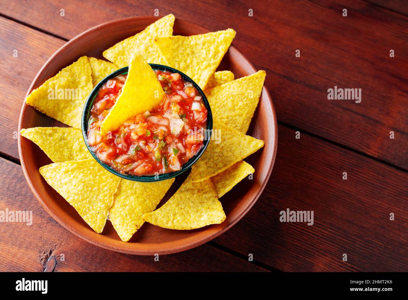 Salsa sauce and nacho chips in a clay bowl. Tortilla chips and salsa ...